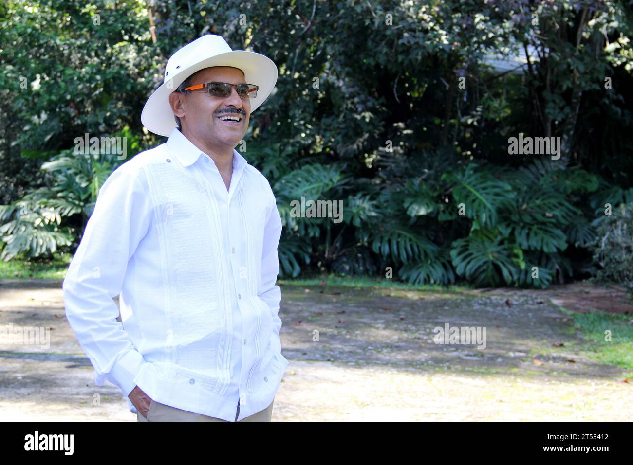 Elderly dark-skinned Latino man in his 60s appears relaxed in his ...