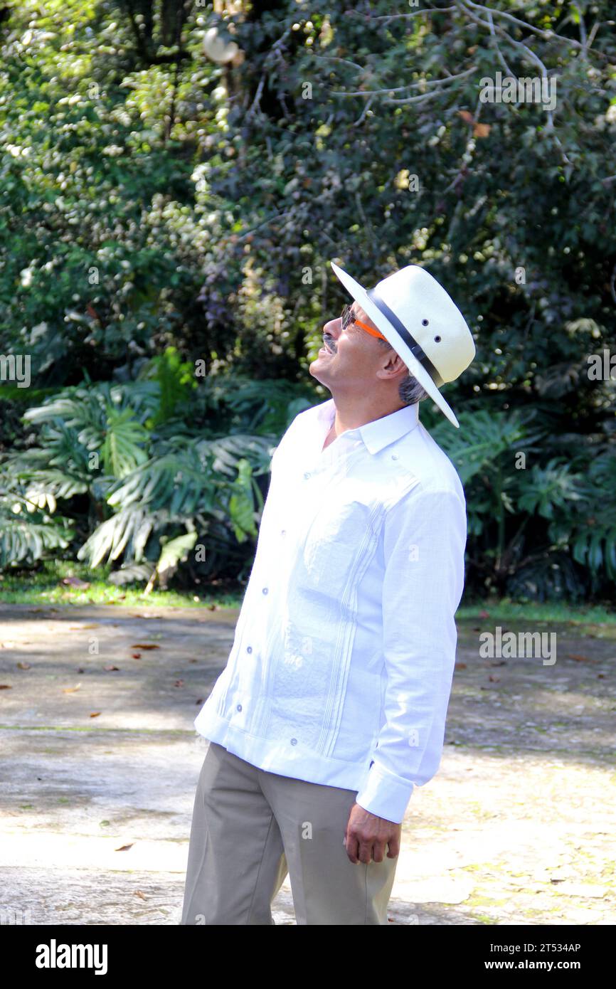 Elderly dark-skinned Latino man in his 60s appears relaxed in his ...