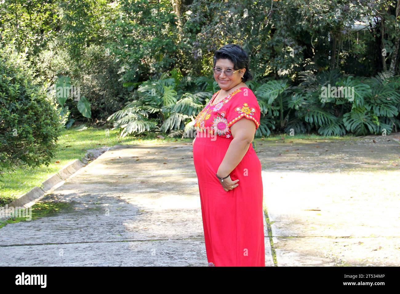 Overweight brunette Latina adult woman in her 50s is happy and proud of ...