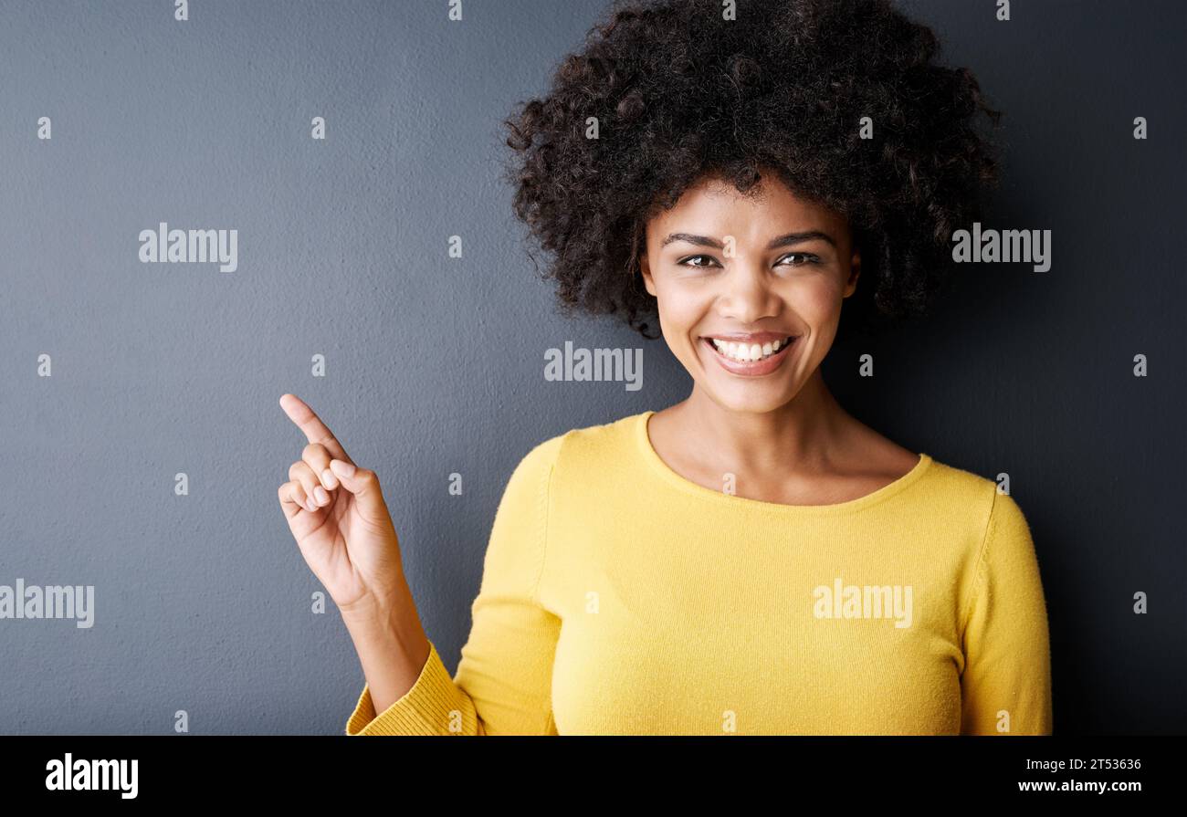 Black woman, pointing and happy portrait in studio, mockup and gray ...
