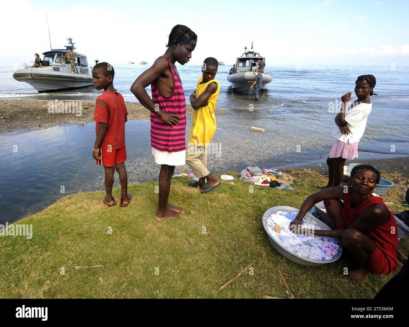 1001195345W-032 BONEL, Haiti (Jan. 19, 2010) Haitian citizens watch as ...
