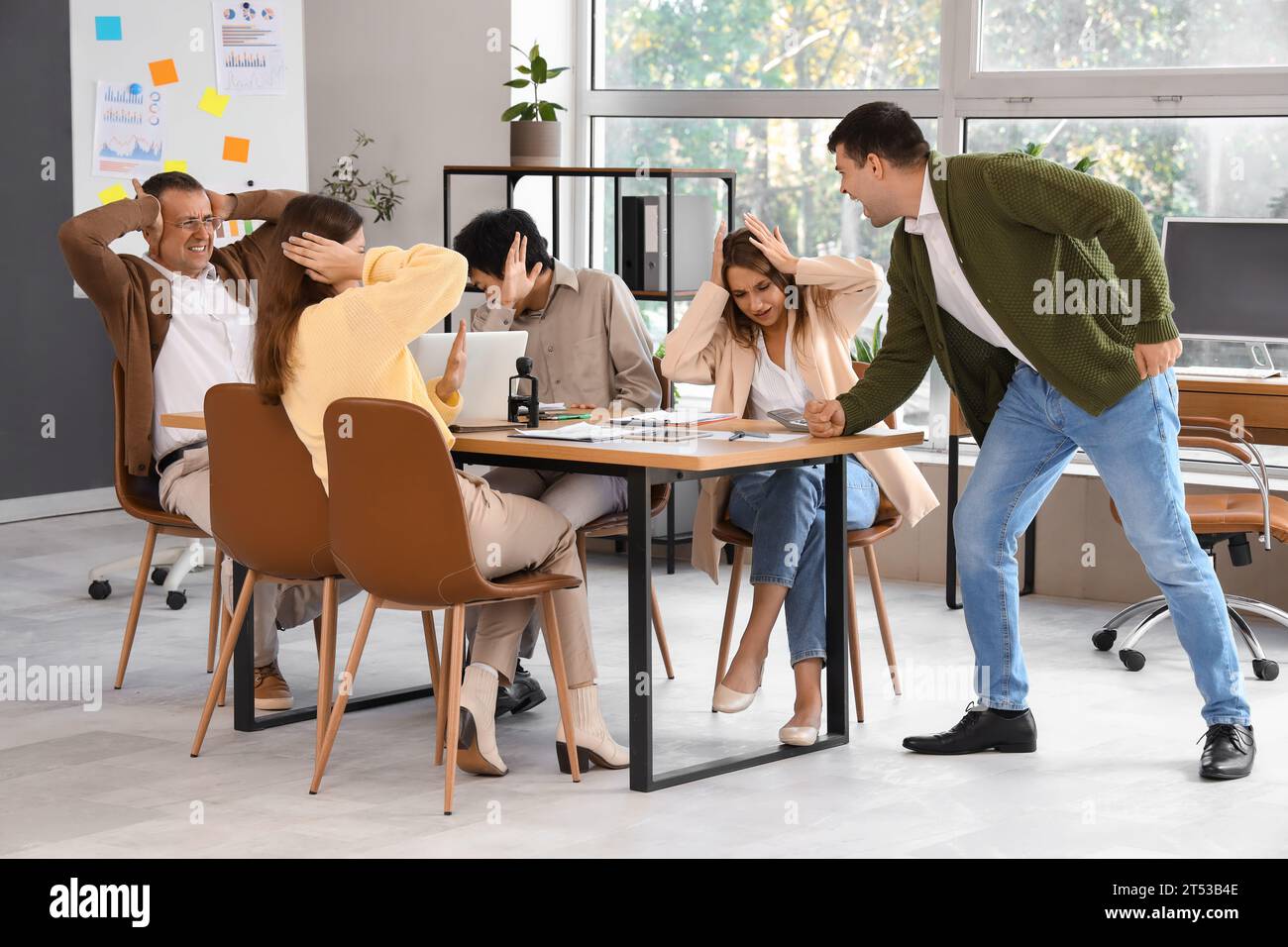 Angry young businessman shouting at colleagues in office Stock Photo ...