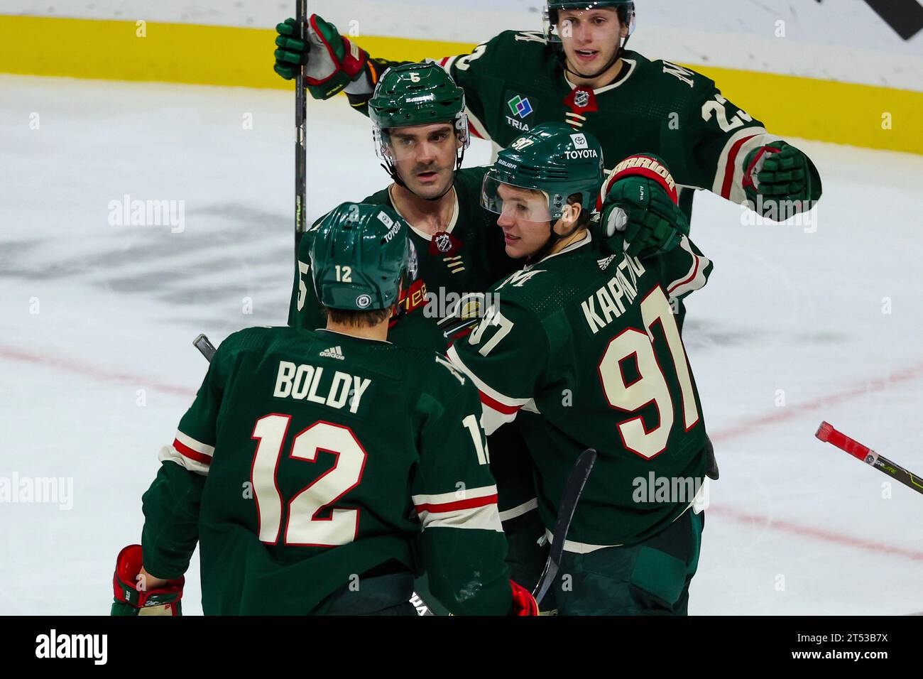Minnesota Wild defenseman Jake Middleton, center left, is congratulated ...
