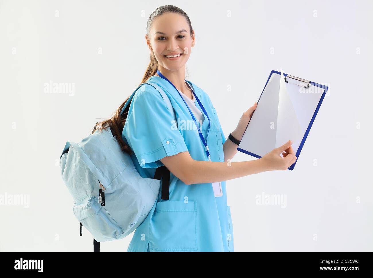 Female medical intern with clipboard on white background Stock Photo ...