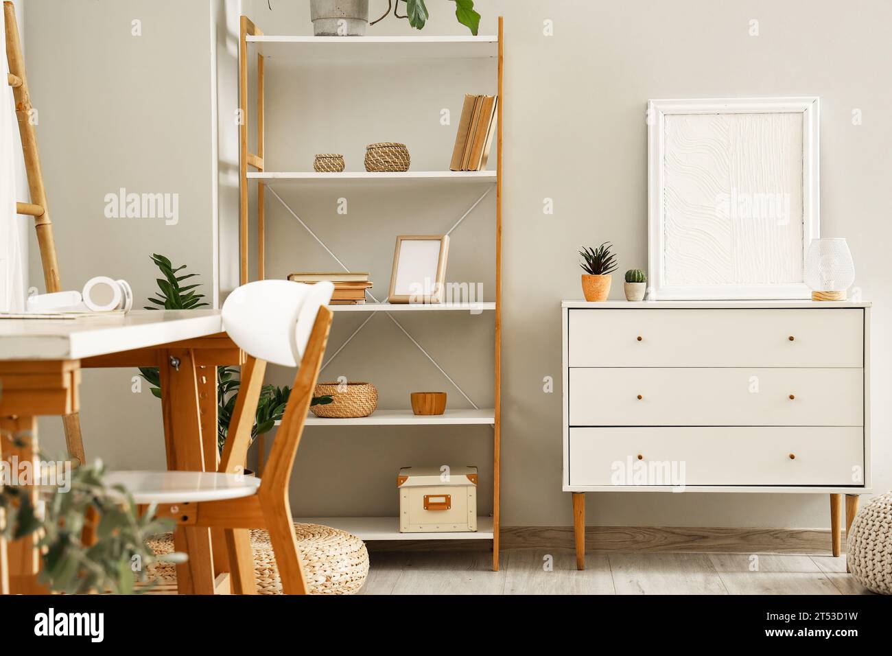 Interior of light living room with commode and shelf unit Stock Photo ...