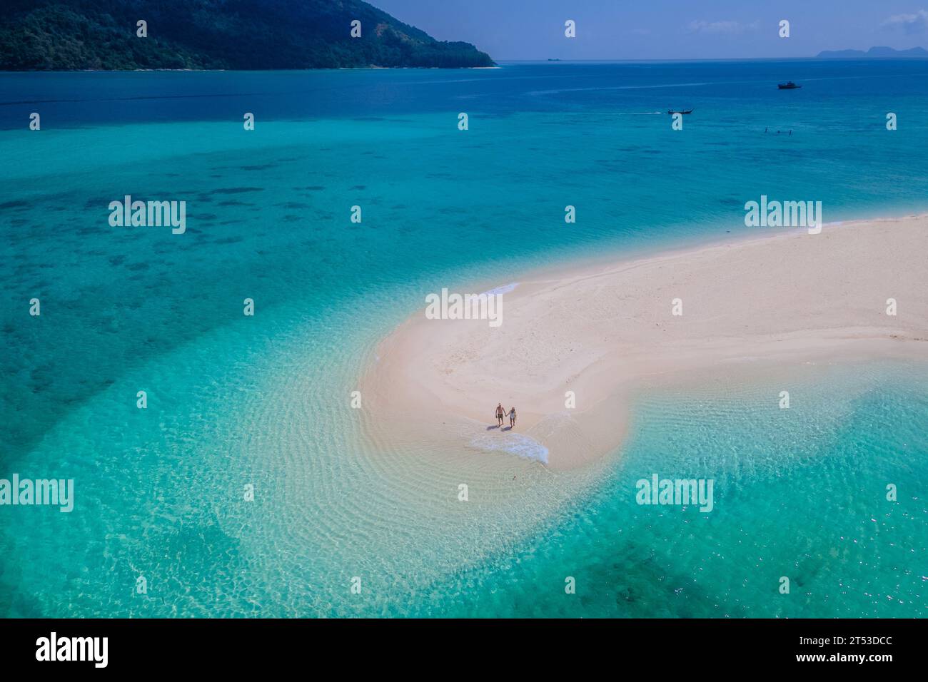 couple of men and women at a white sandbank in the ocean of Koh Lipe Island Southern Thailand ...