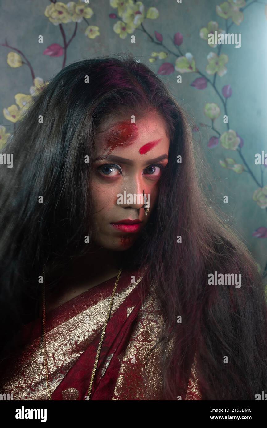 Beautiful young woman suffer head and face trauma in dramatic light ...