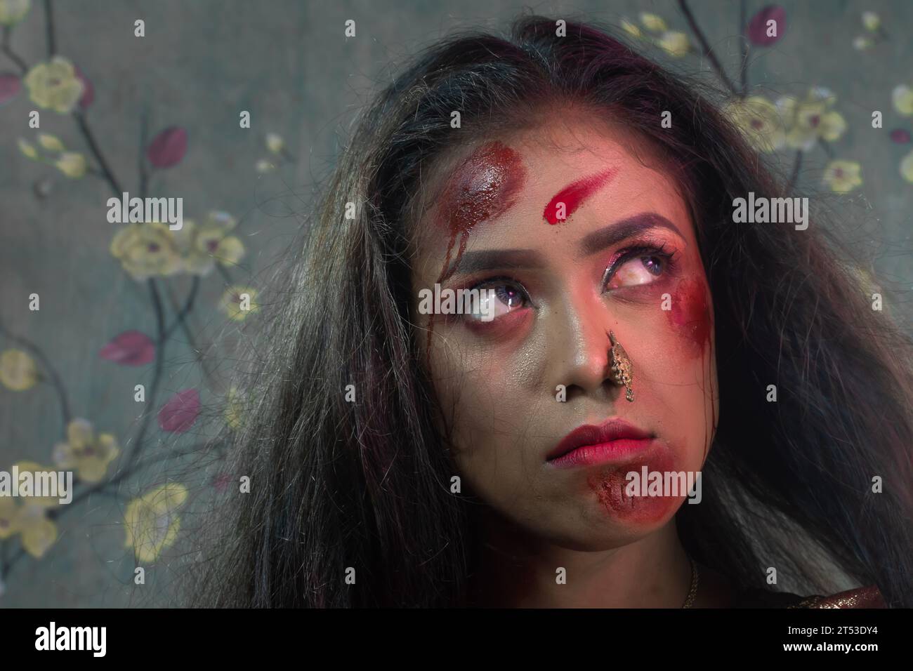 Beautiful young woman suffer head and face trauma in dramatic light ...