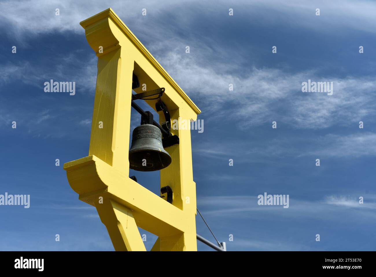 A tall bell tower, standing tall and majestic against a clear blue sky ...