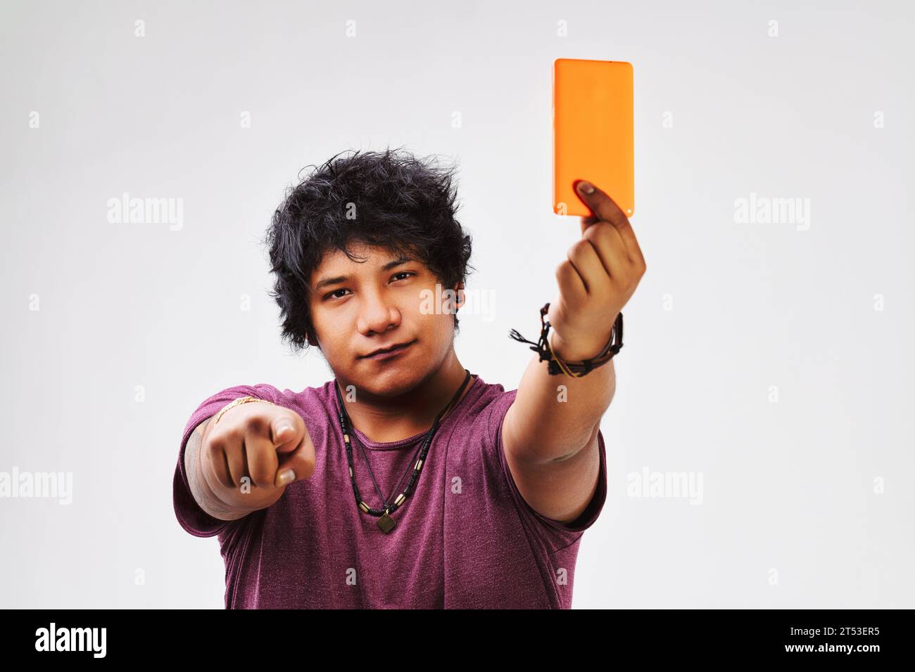 Emulating a soccer referee, the young man's gesture with his phone ...