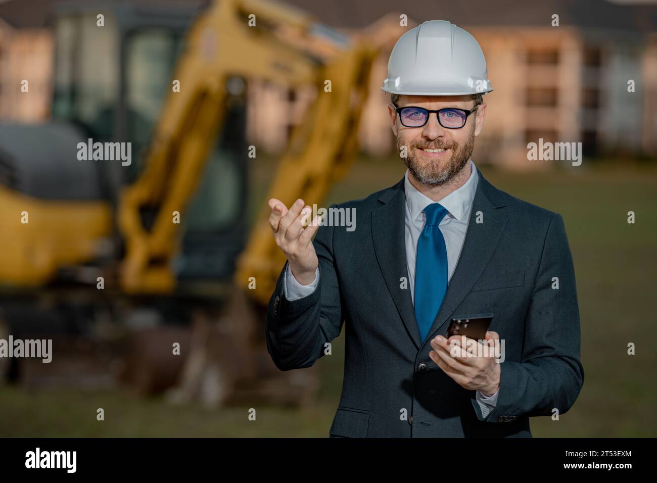 Successful construction business owner. Construction worker in suit and ...