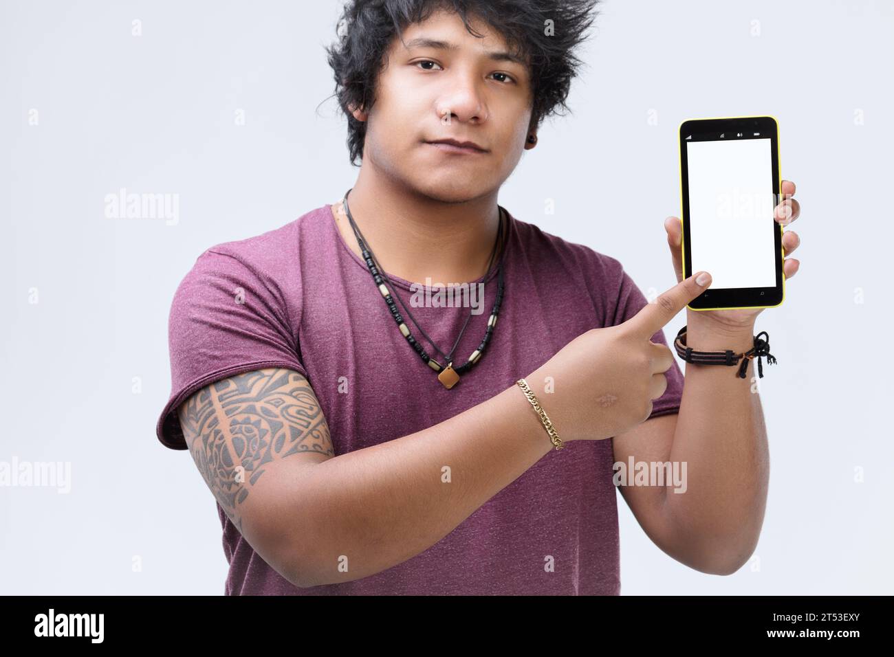 With a confident demeanor, the man with tan skin and curly hair points ...