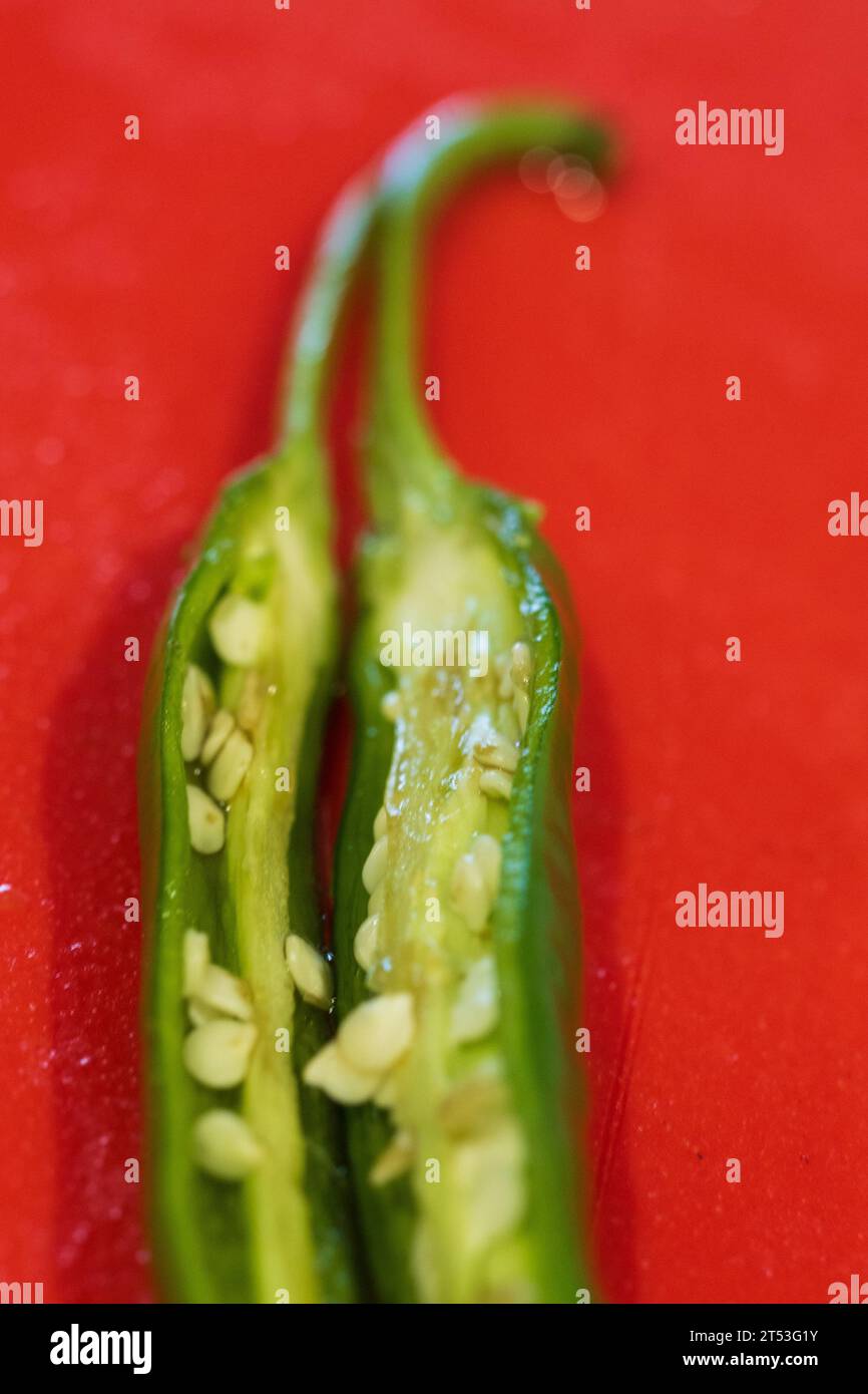 Closeup of homegrown green chilli cut in half to show seeds Stock Photo ...