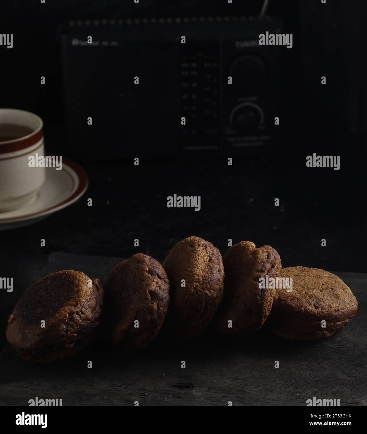 Apang bale cake or Apang bakar, and a cup of tea isolated on black ...