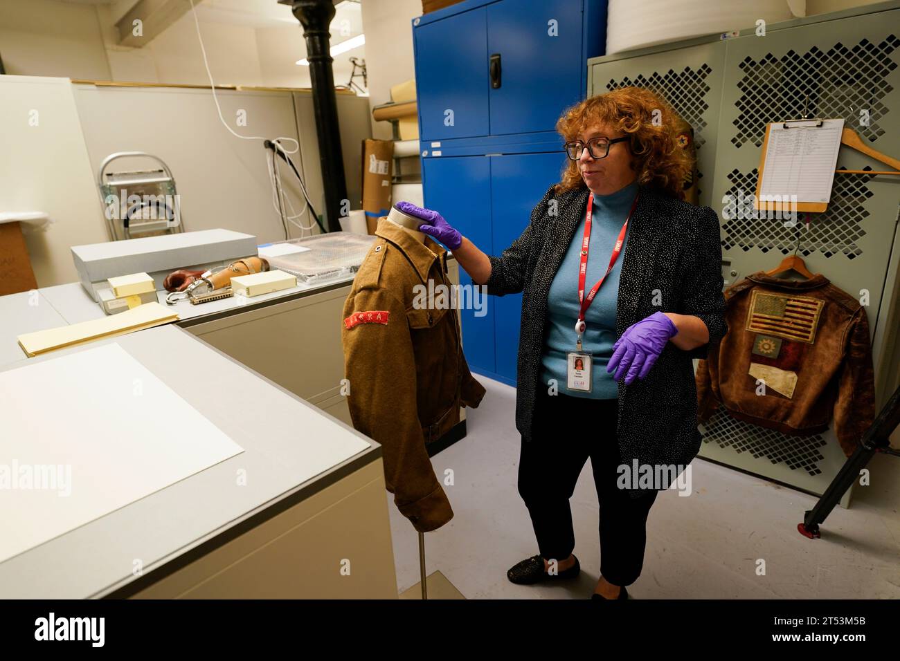 Kim Guise, curator for the National World War II Museum, shows a jacket ...