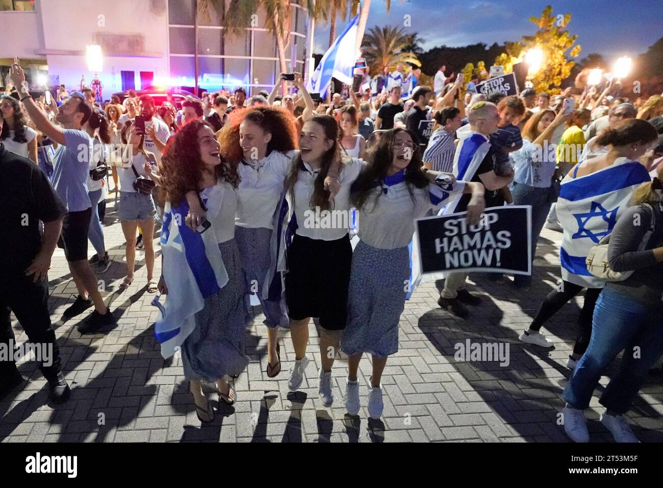 FILE - A group of Israeli girls jump and sing as they attend a rally in ...