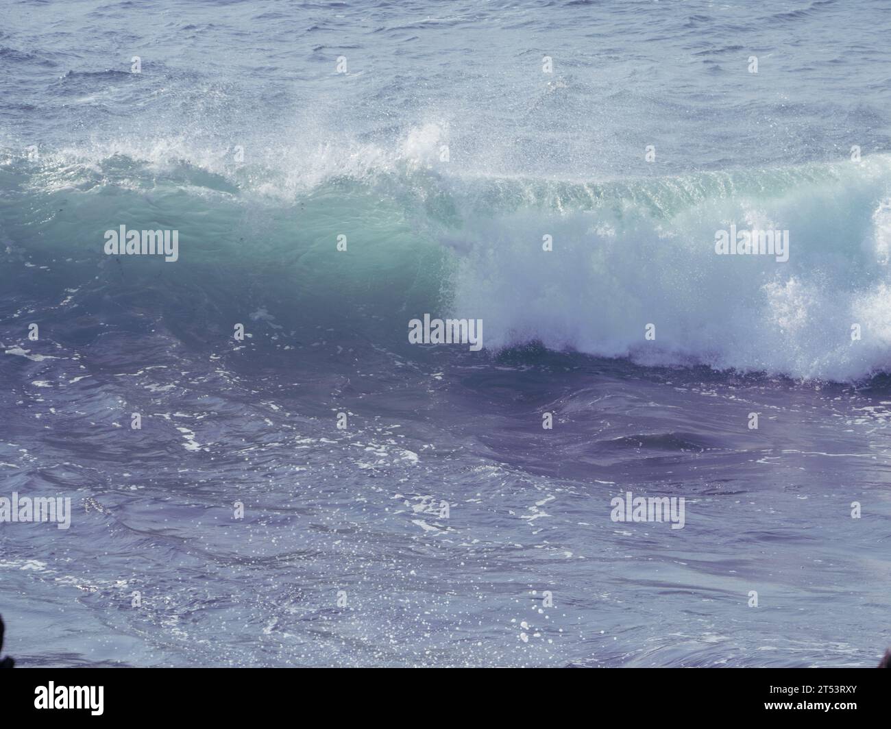 A blue green sea wave breaking near shore Stock Photo - Alamy
