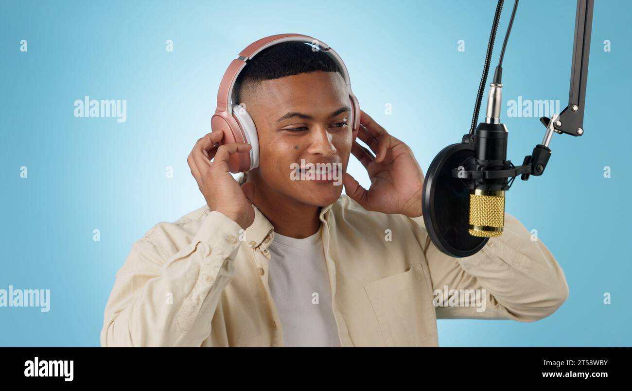 Artist man, headphones and mic in studio with thinking, ideas and ...