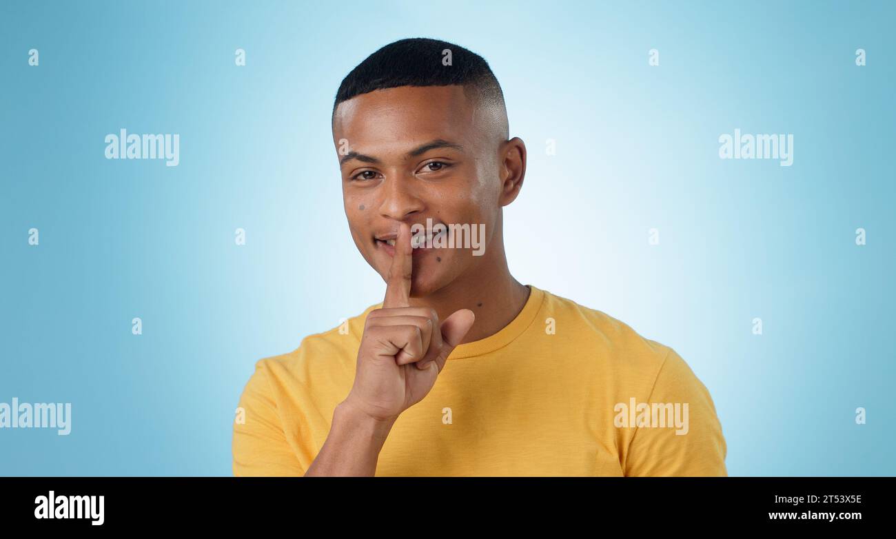 Man, portrait and finger on lips for quiet sign, secret deal or smile ...