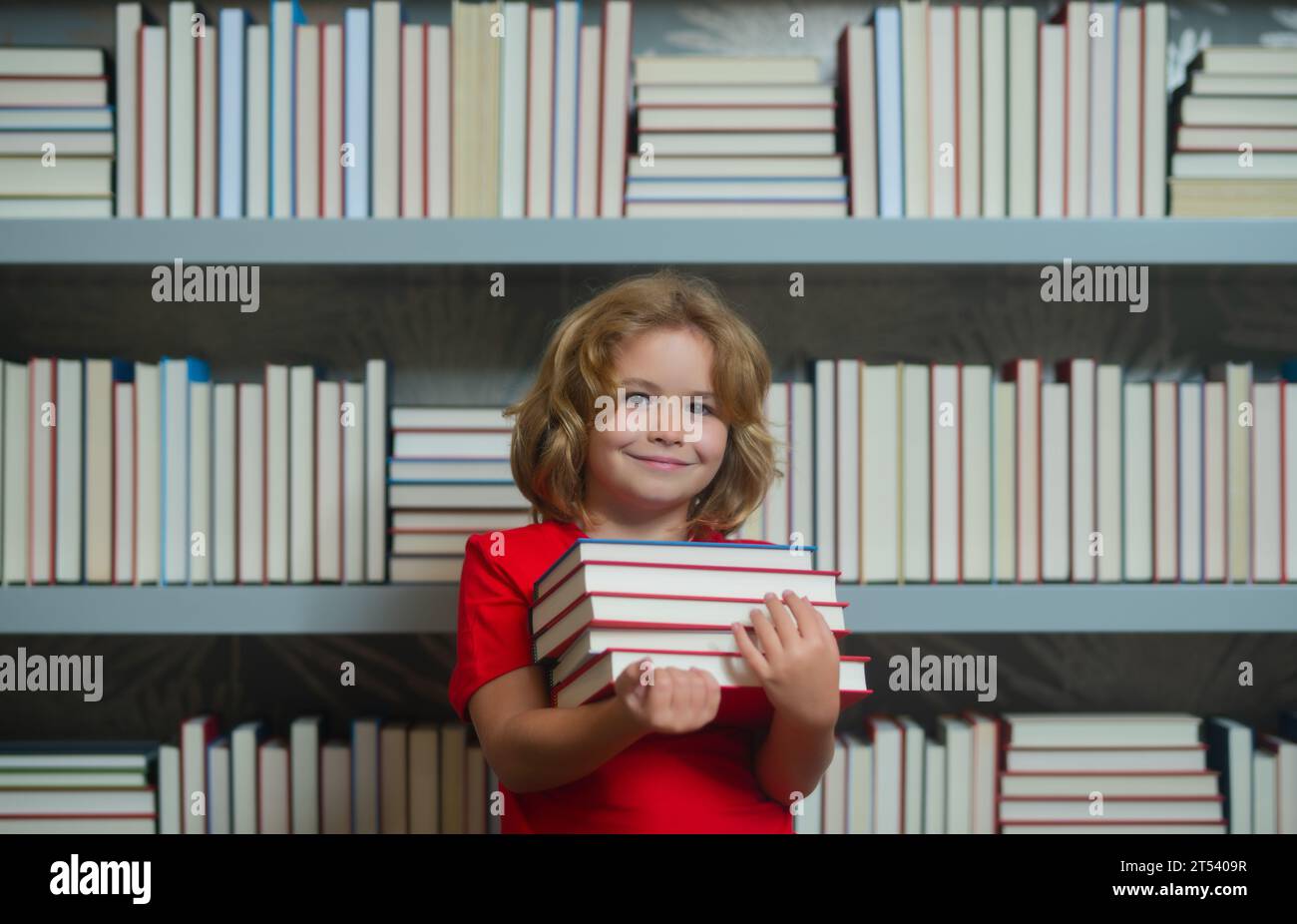 Elementary schoolboy. School pupil with pile of books. Children ...