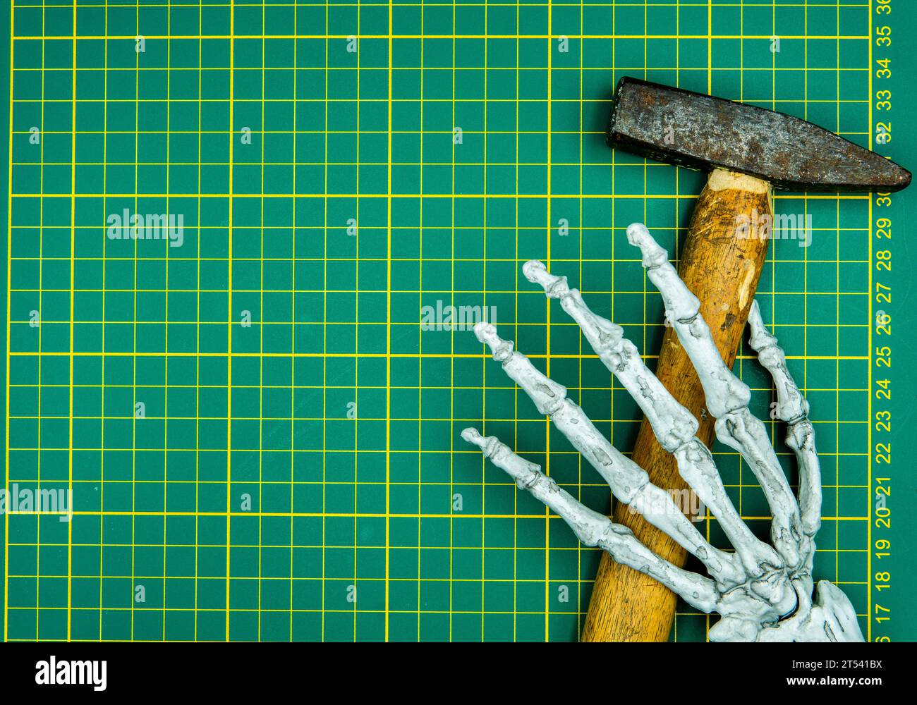 death lending a helping hand skeleton hand holding a hammer on green ...