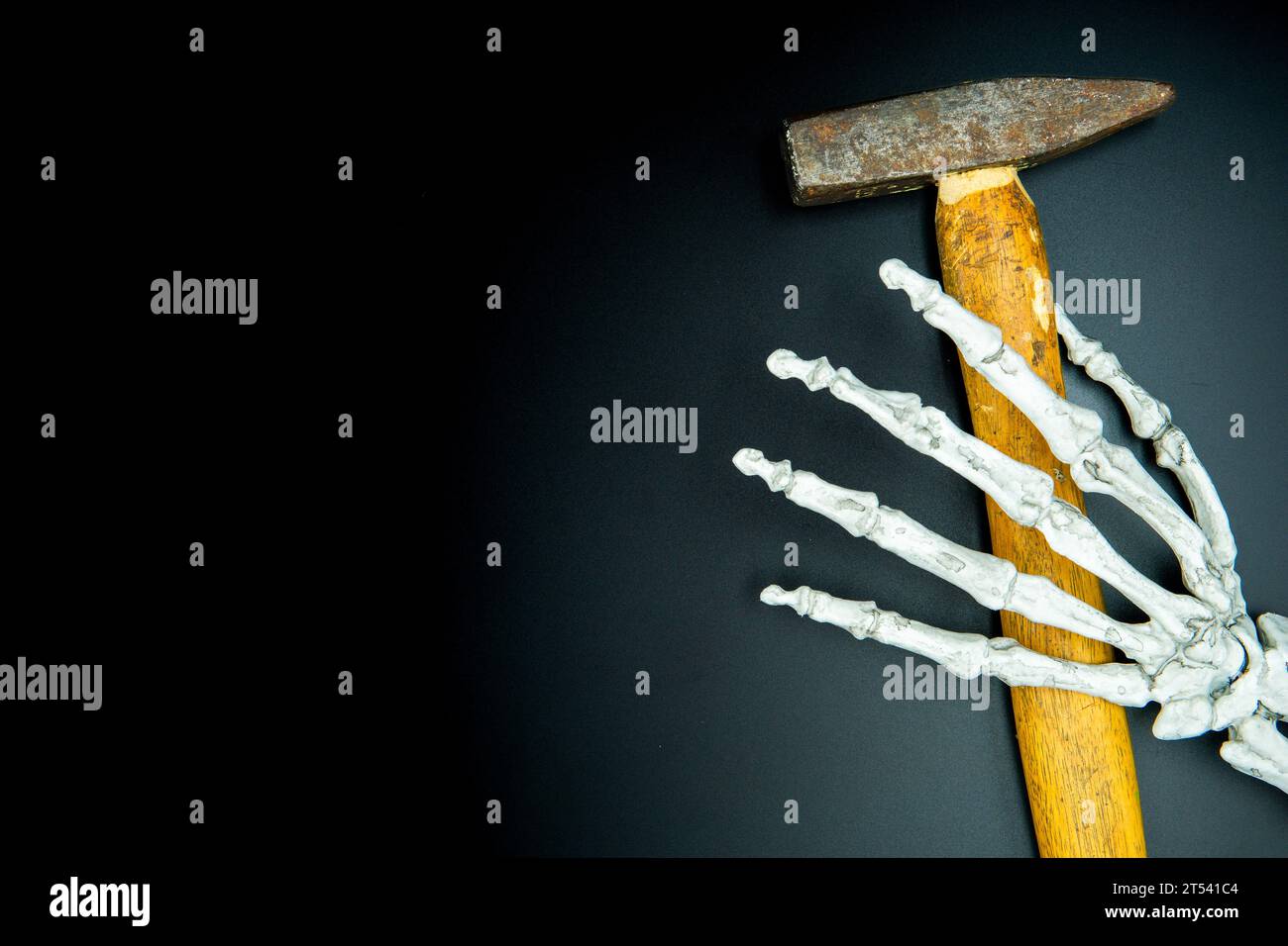 death lending a helping hand skeleton hand holding a hammer Stock Photo ...