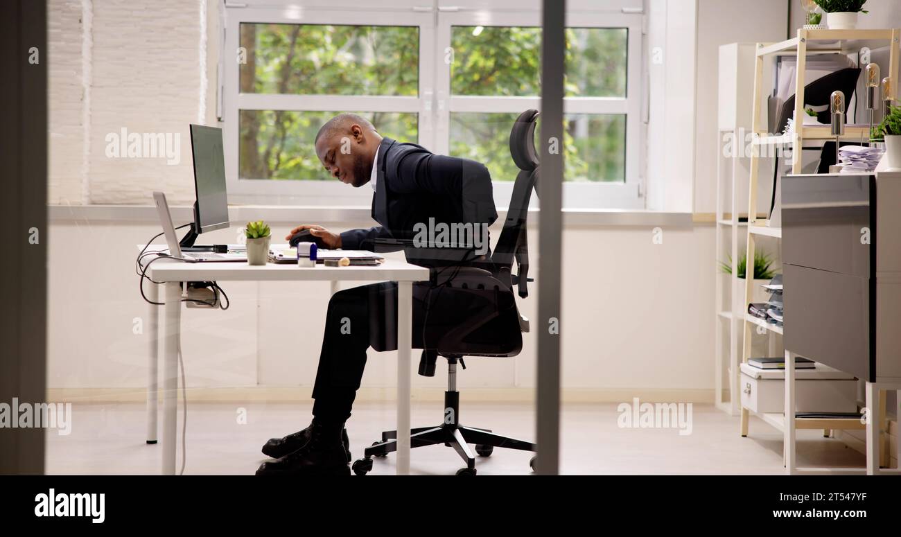 Back Pain Bad Posture Man Sitting In Office Stock Photo - Alamy