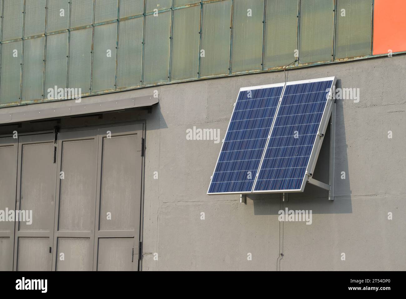 Solar panels attached to a house wall Stock Photo - Alamy