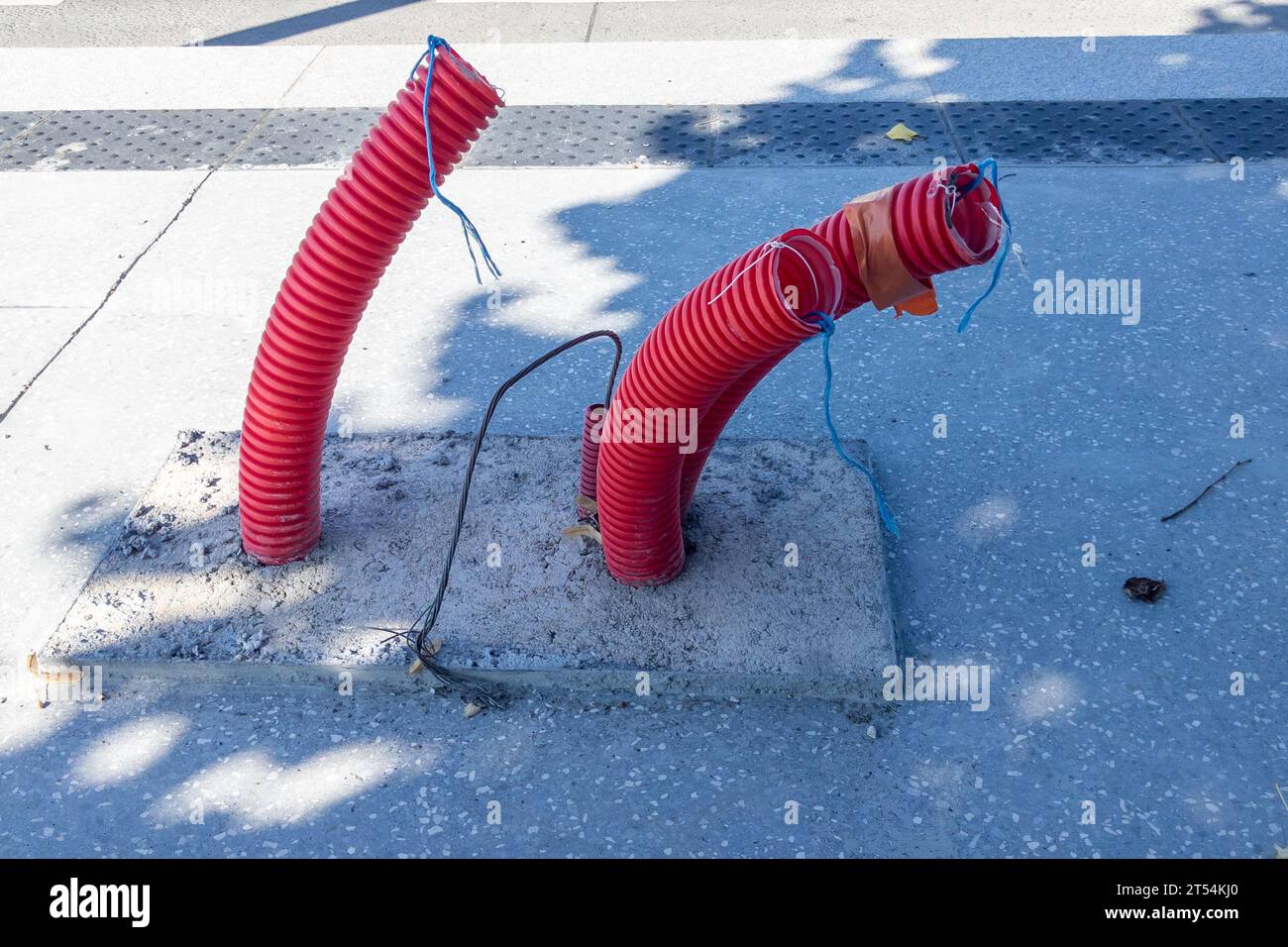 Flexible plastic red pipeline for electric cable coming out from the ...