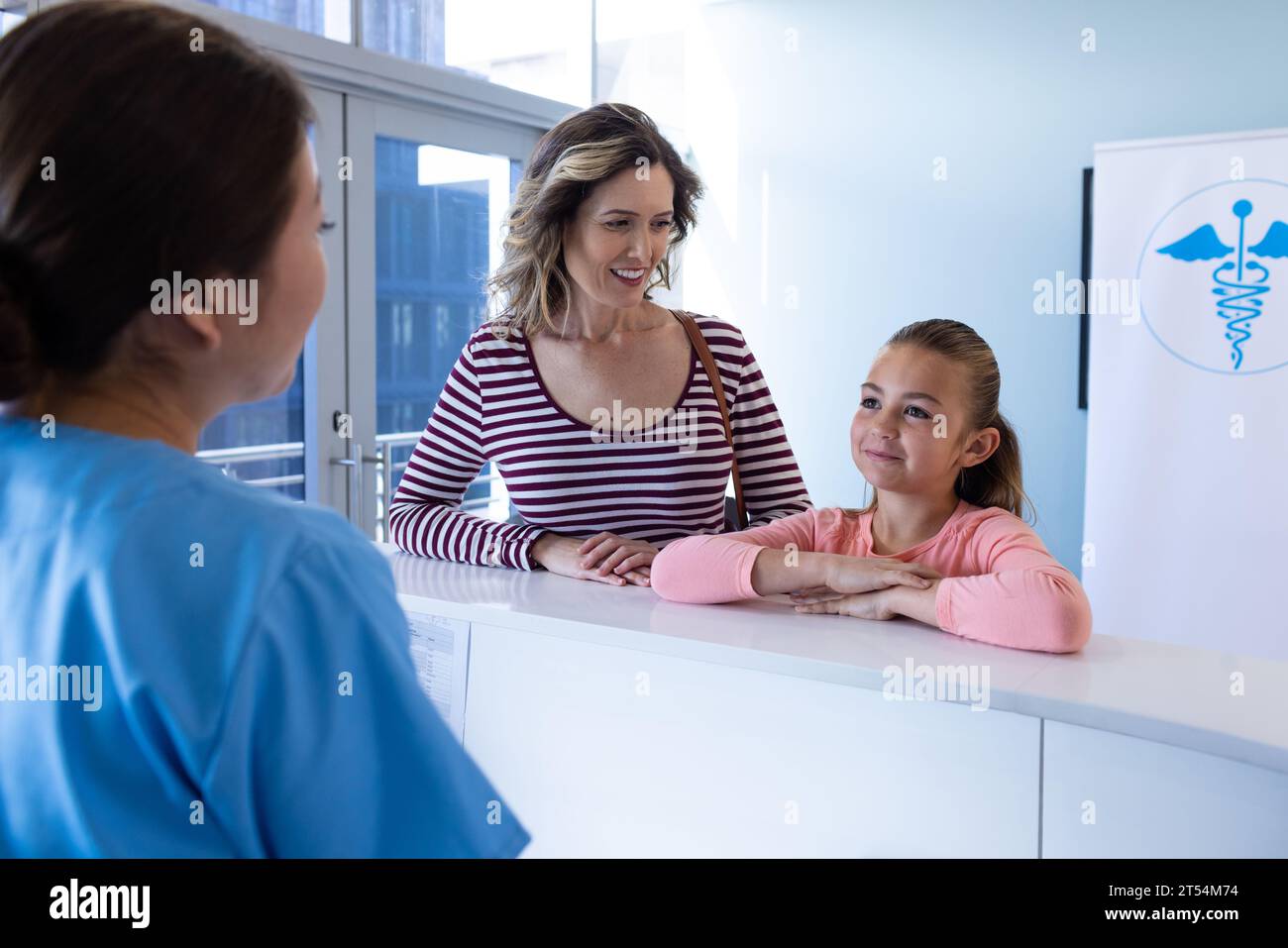 Happy diverse daughter patient and mother talking with female doctor at ...