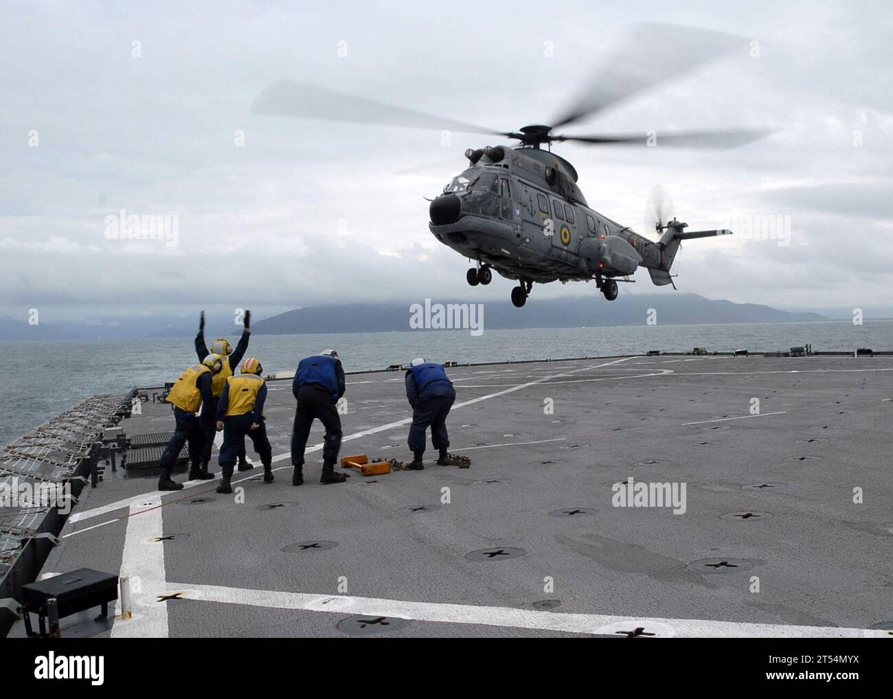 Director, flight deck, landing, Puma, signaling, UH-14, yellow shirt ...
