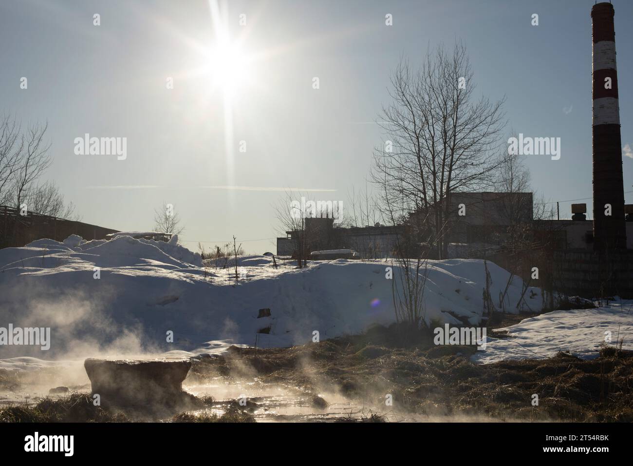 Pipe factory. Discharge of waste into the field. A rusty pipe sticks ...