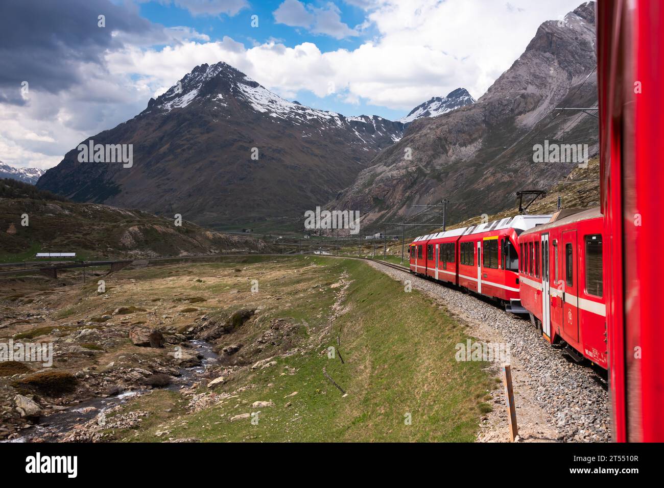 Red train going in beautiful landscape, Switzerland Stock Photo - Alamy