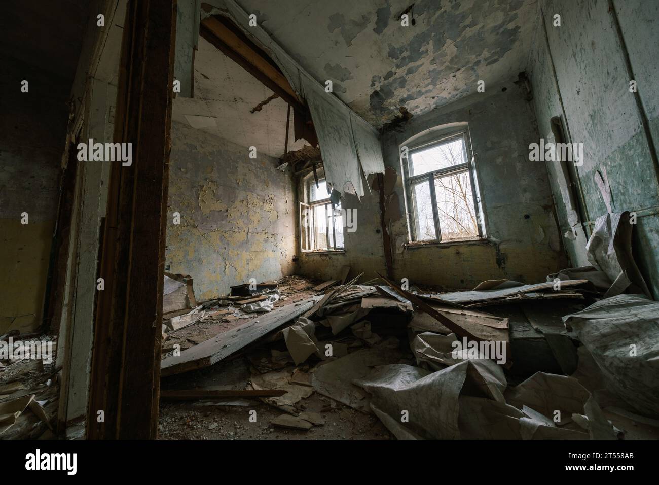 From above interior of shabby abandoned room with peeling painted walls ...