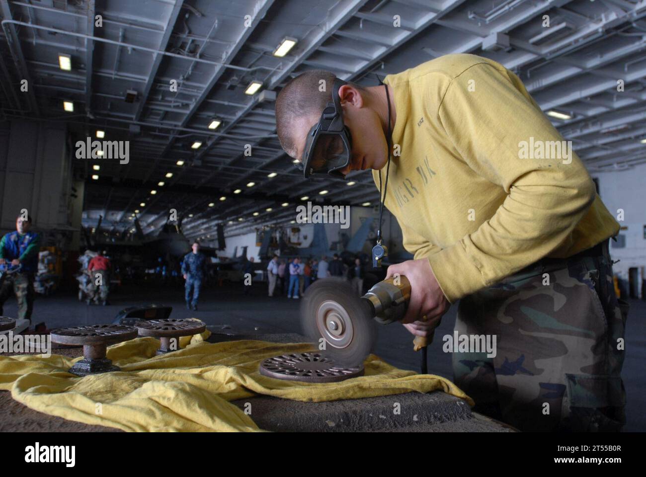 HANGAR BAY, Pacific Ocean, polishing metal deck drains, U.S. navy , USS ...