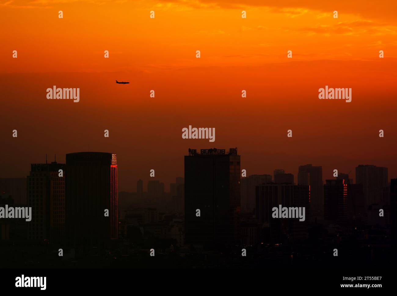 A plane flying in the sunset to Noi Bai airport, Hanoi, Vietnam Stock ...
