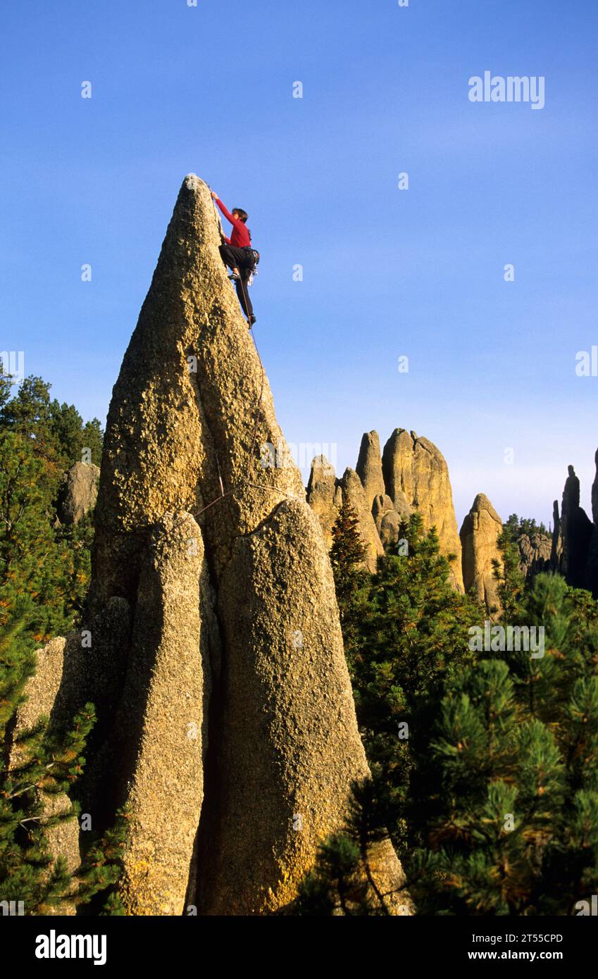 Female rock climber atop a granite spire, South Dakota Stock Photo - Alamy