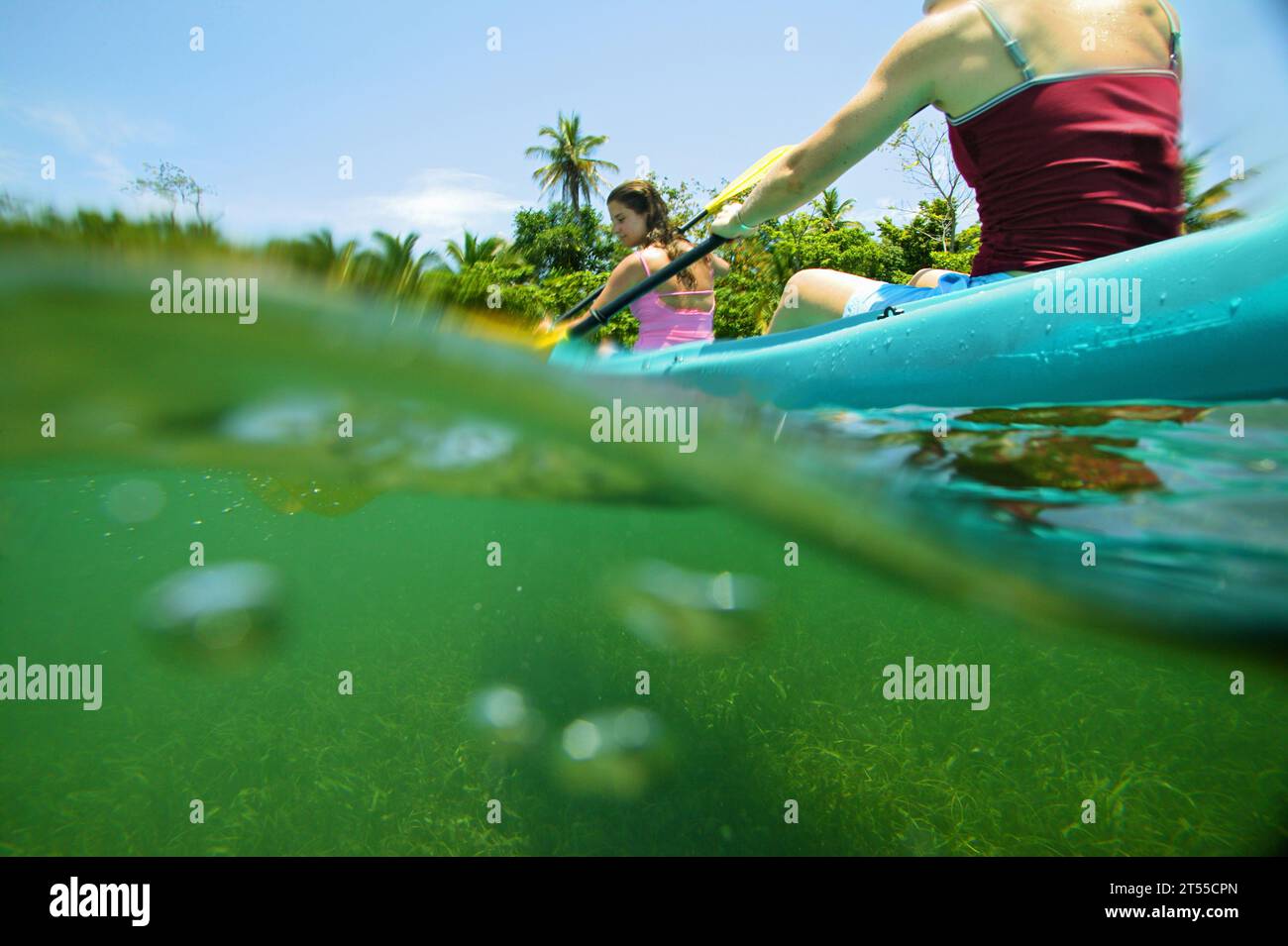 Two women paddling a sea kayak on Caribbean Sea near Bocas del Toro ...