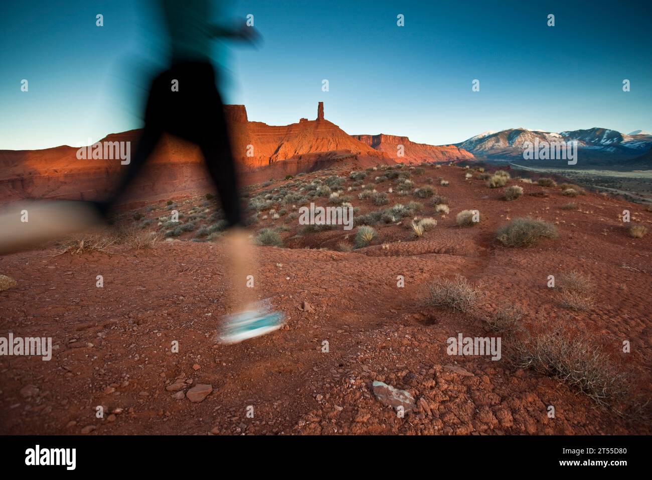 Woman running in beautiful desert environment, Castle Valley, Utah ...