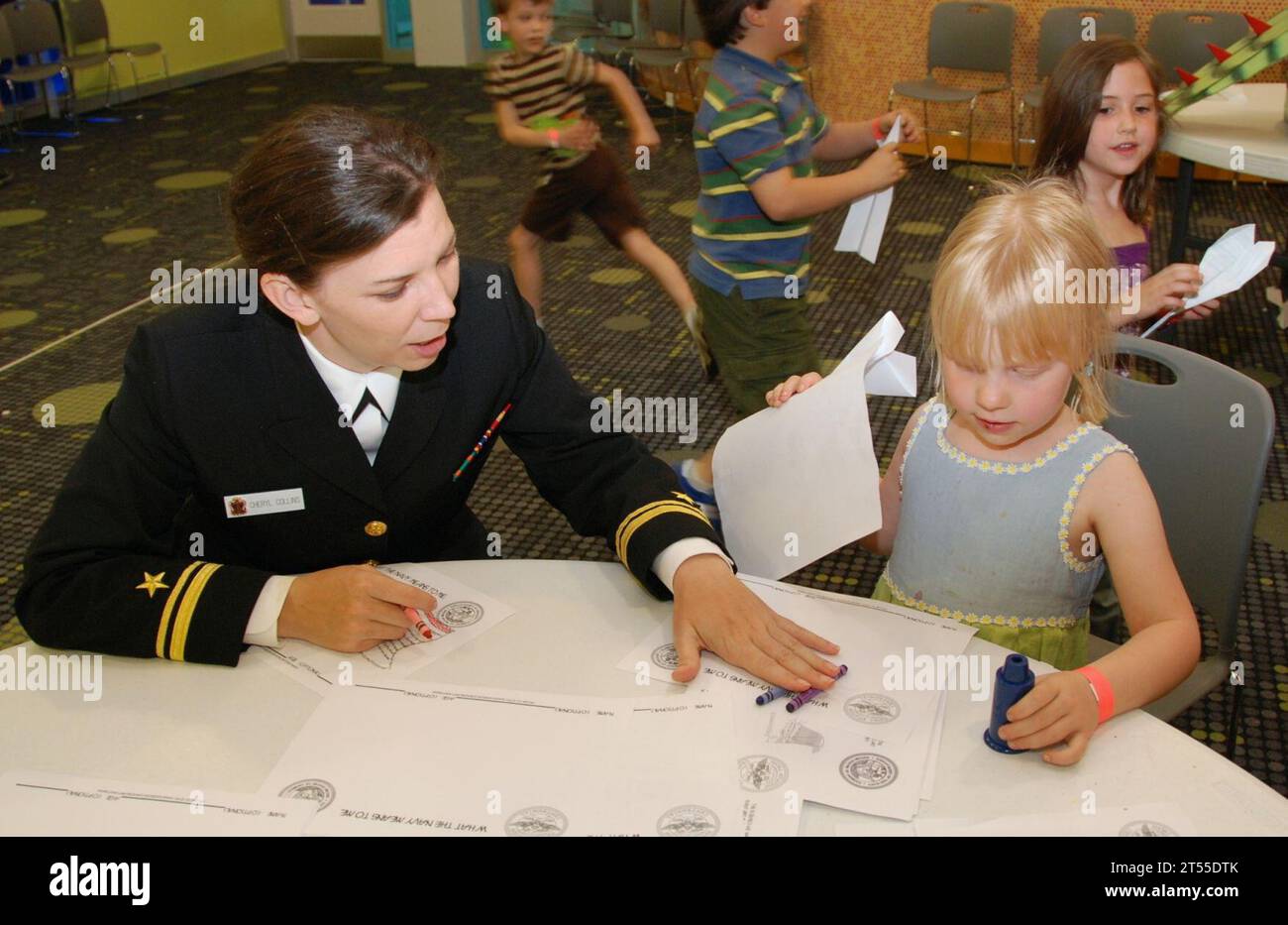 helps a child color at the Mississippi Children's Museum during ...
