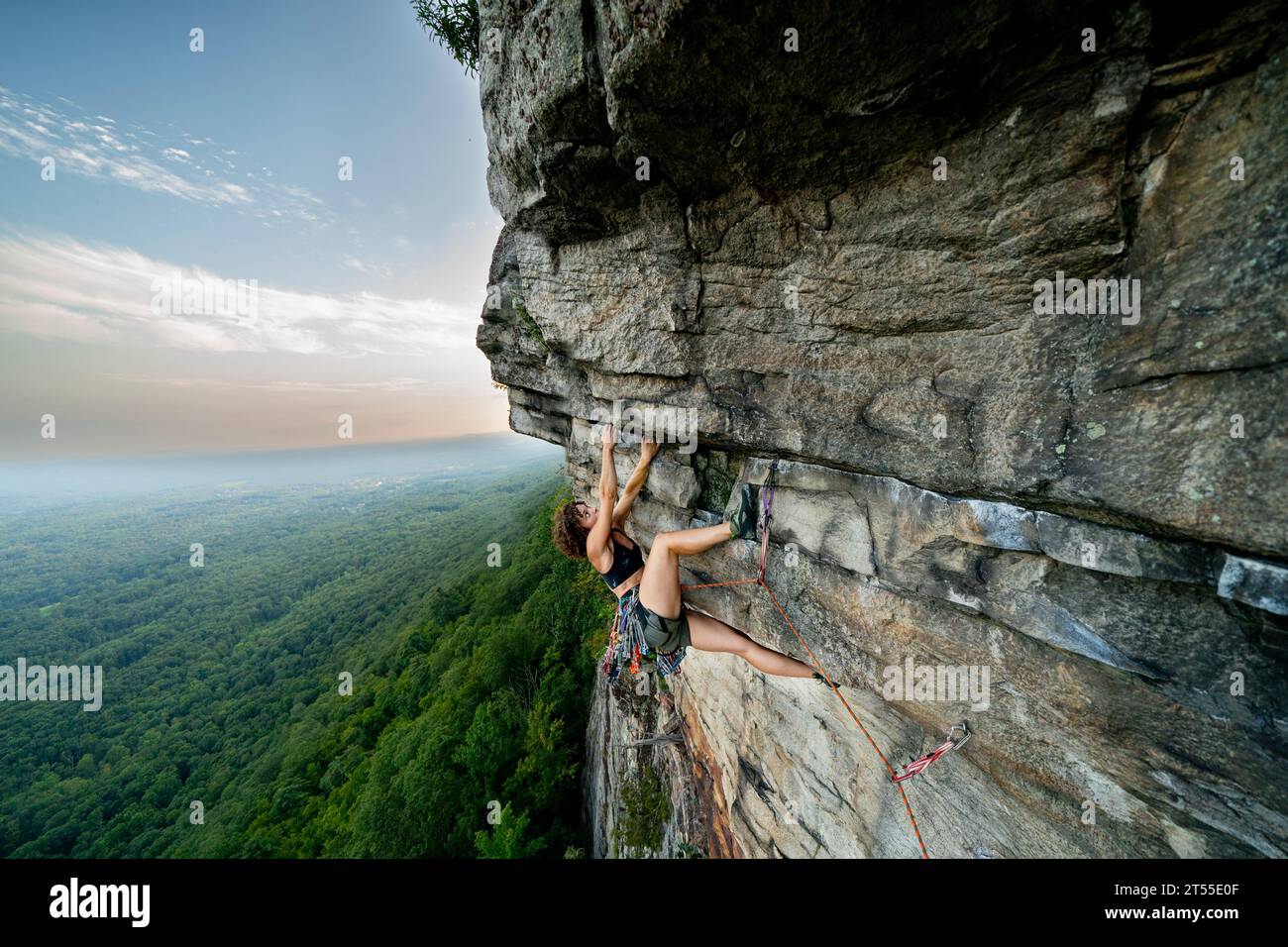 Rock Climbing Woman Leading at Sunset Stock Photo - Alamy
