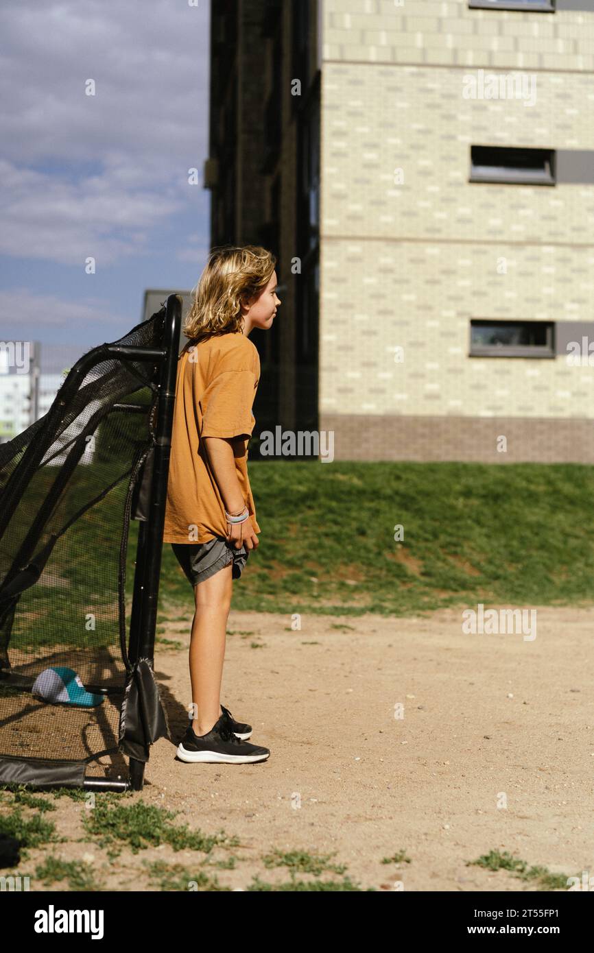 Teenage boys play football in the yard Stock Photo - Alamy