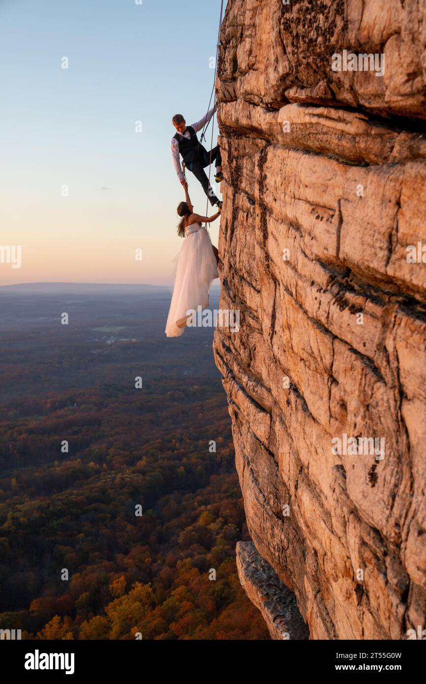 Rock Climbing wedding Bride and Groom at Sunrise Stock Photo - Alamy