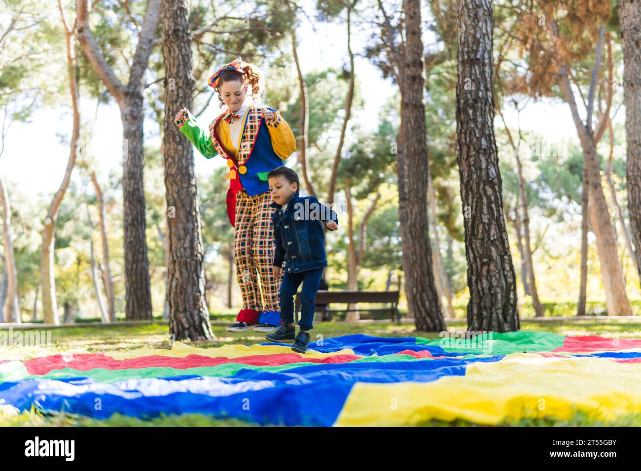 girl dressed as a clown playing with a child Stock Photo - Alamy