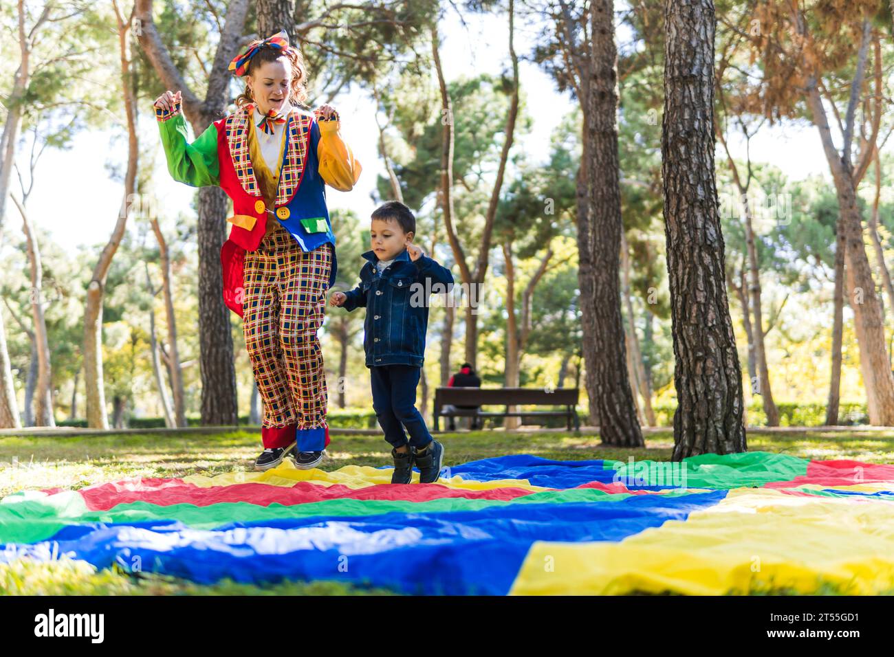 girl dressed as a clown playing with a child Stock Photo - Alamy
