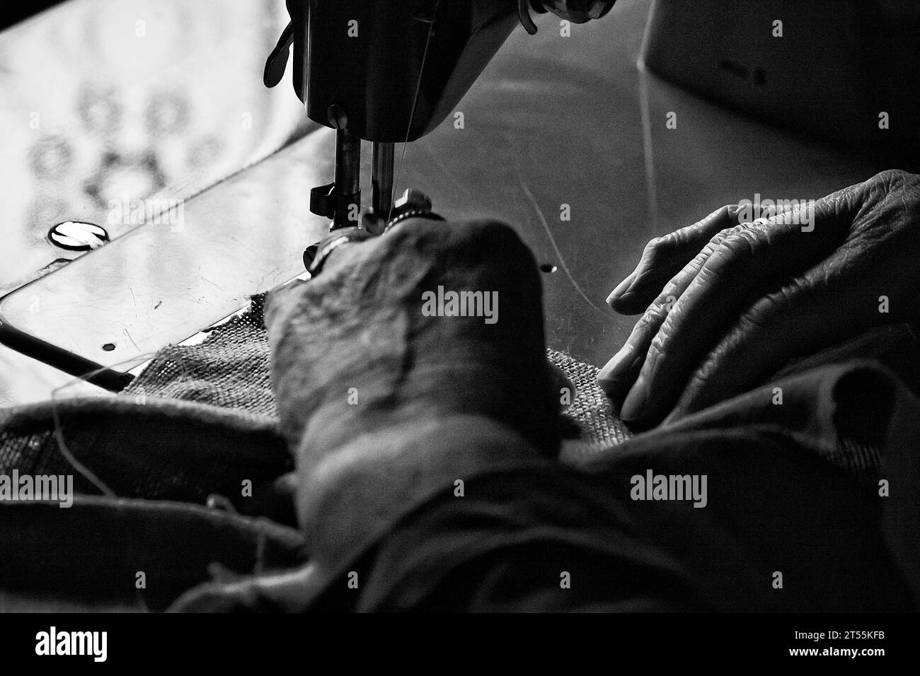 Senior woman sewing with sewing machine Stock Photo - Alamy