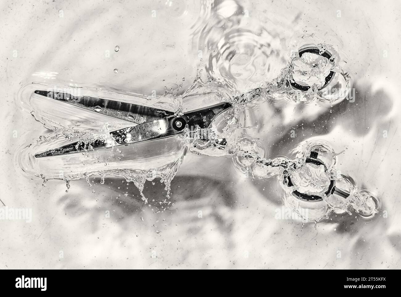 scissors falling into the water Stock Photo - Alamy