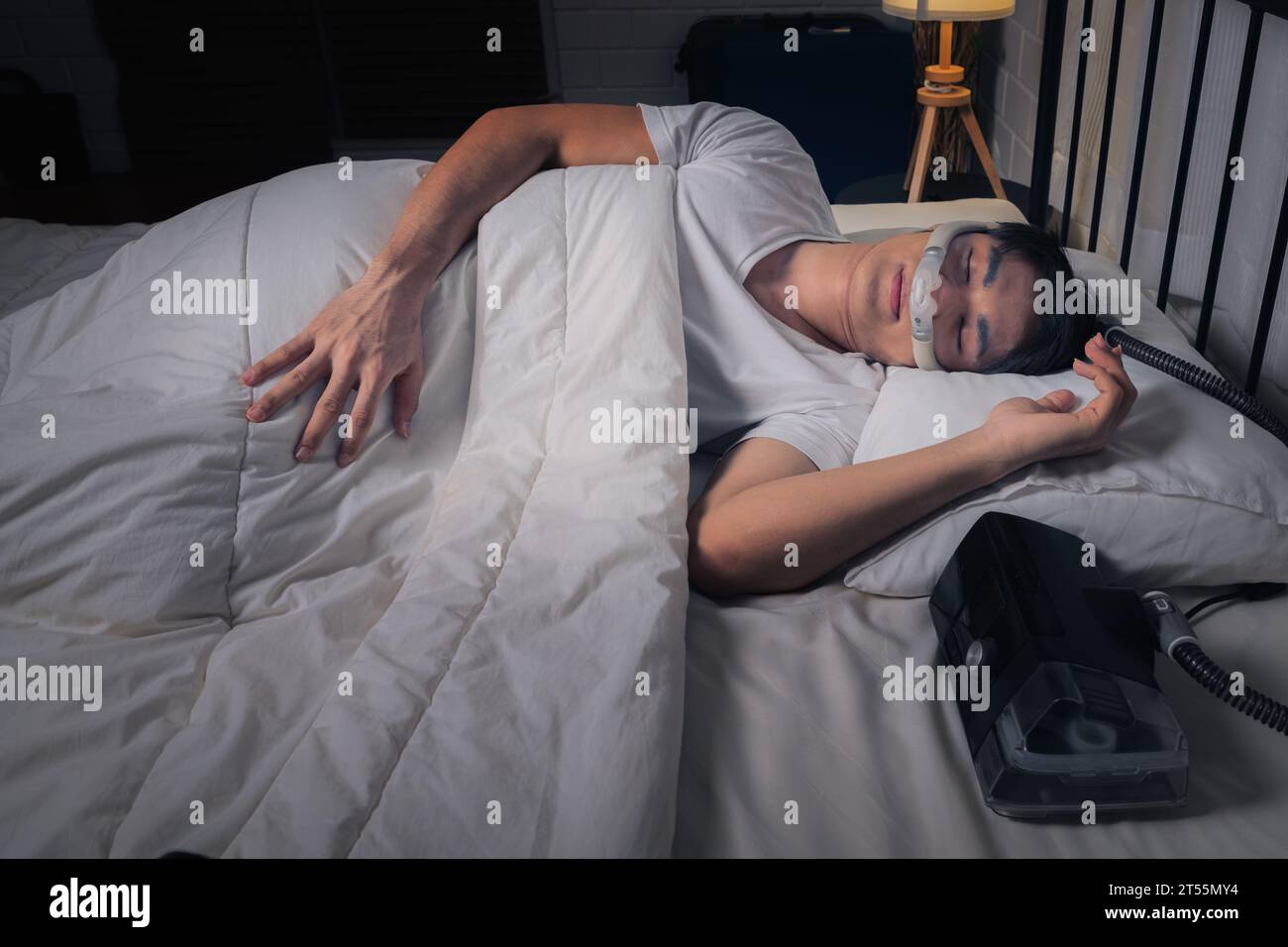 Happy and healthy Asian man with CPAP machine on side table wearing ...