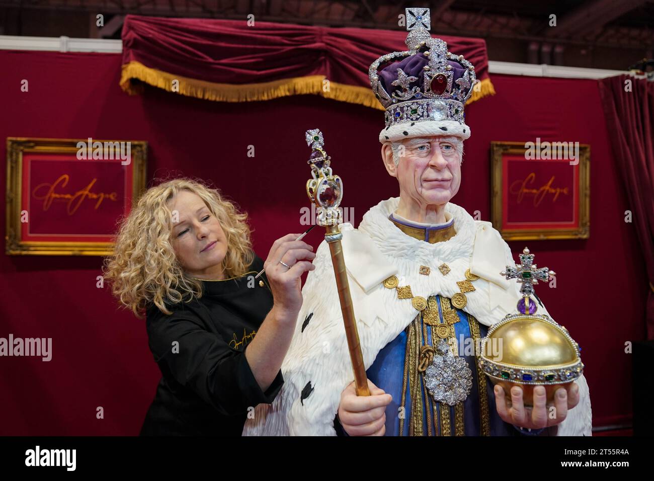 The finishing touches are applied to a lifesize cake figure of King ...