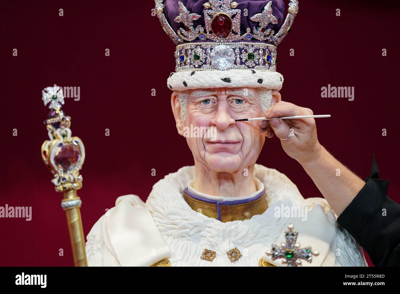 The finishing touches are applied to a lifesize cake figure of King ...